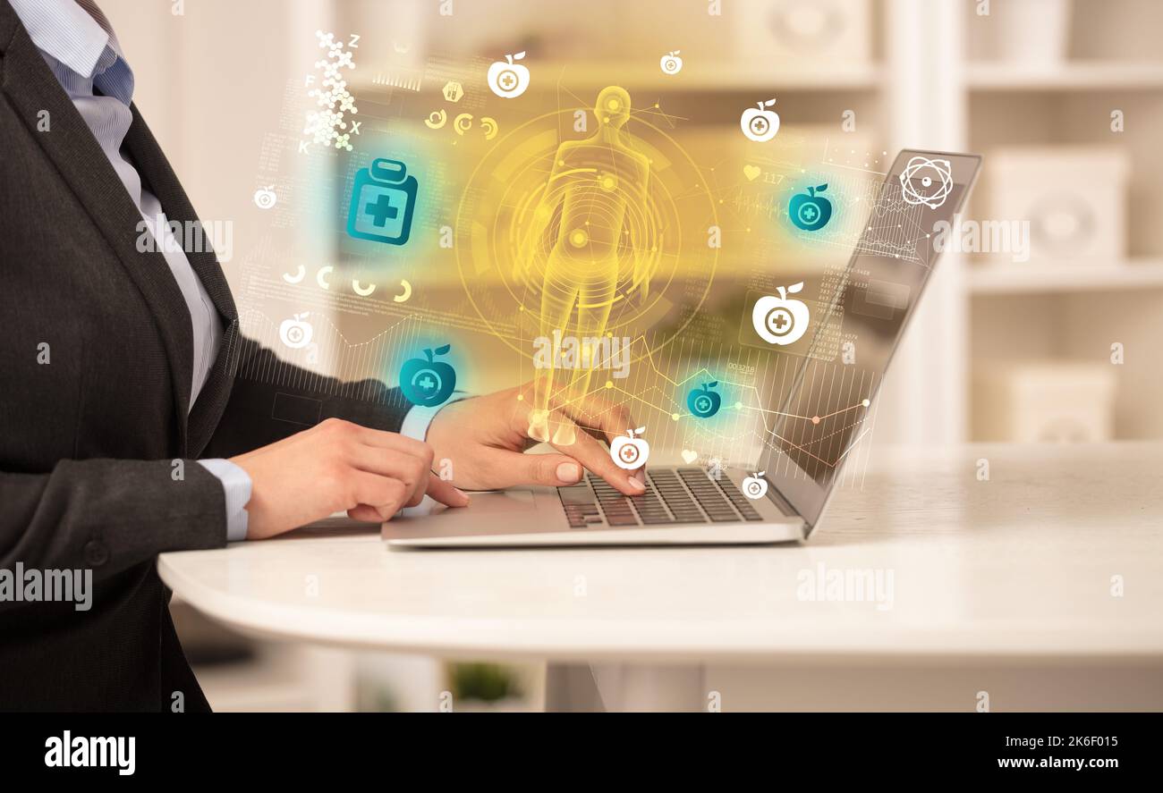 Doctor working on laptop with healthcare concept Stock Photo - Alamy