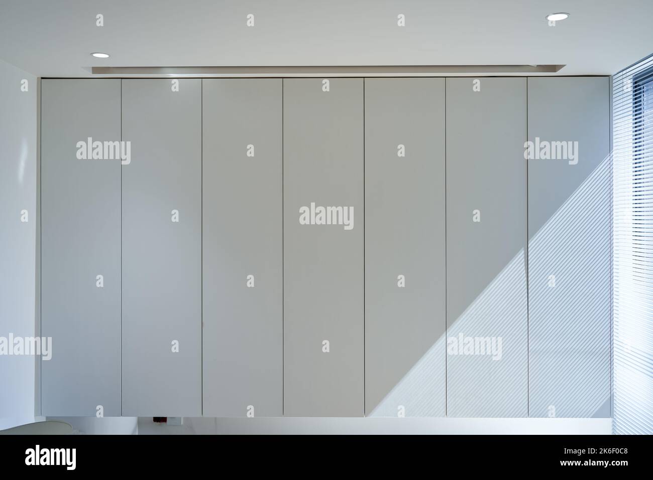 A ray of sunlight hits a white locker in a modern home renovation Stock ...