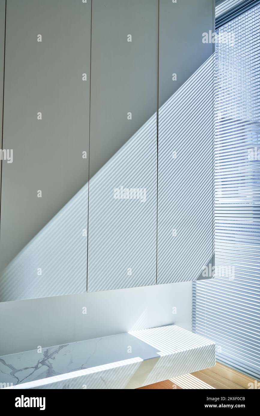 A ray of sunlight hits a white locker in a modern home renovation Stock ...