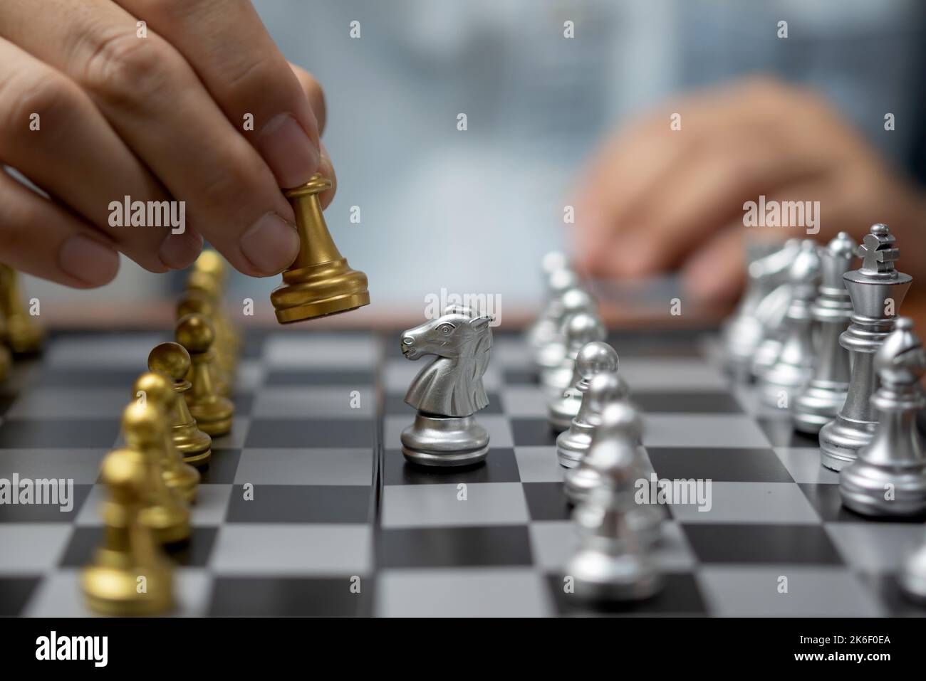 Businessman play on chess board game for ideas and competition and ...