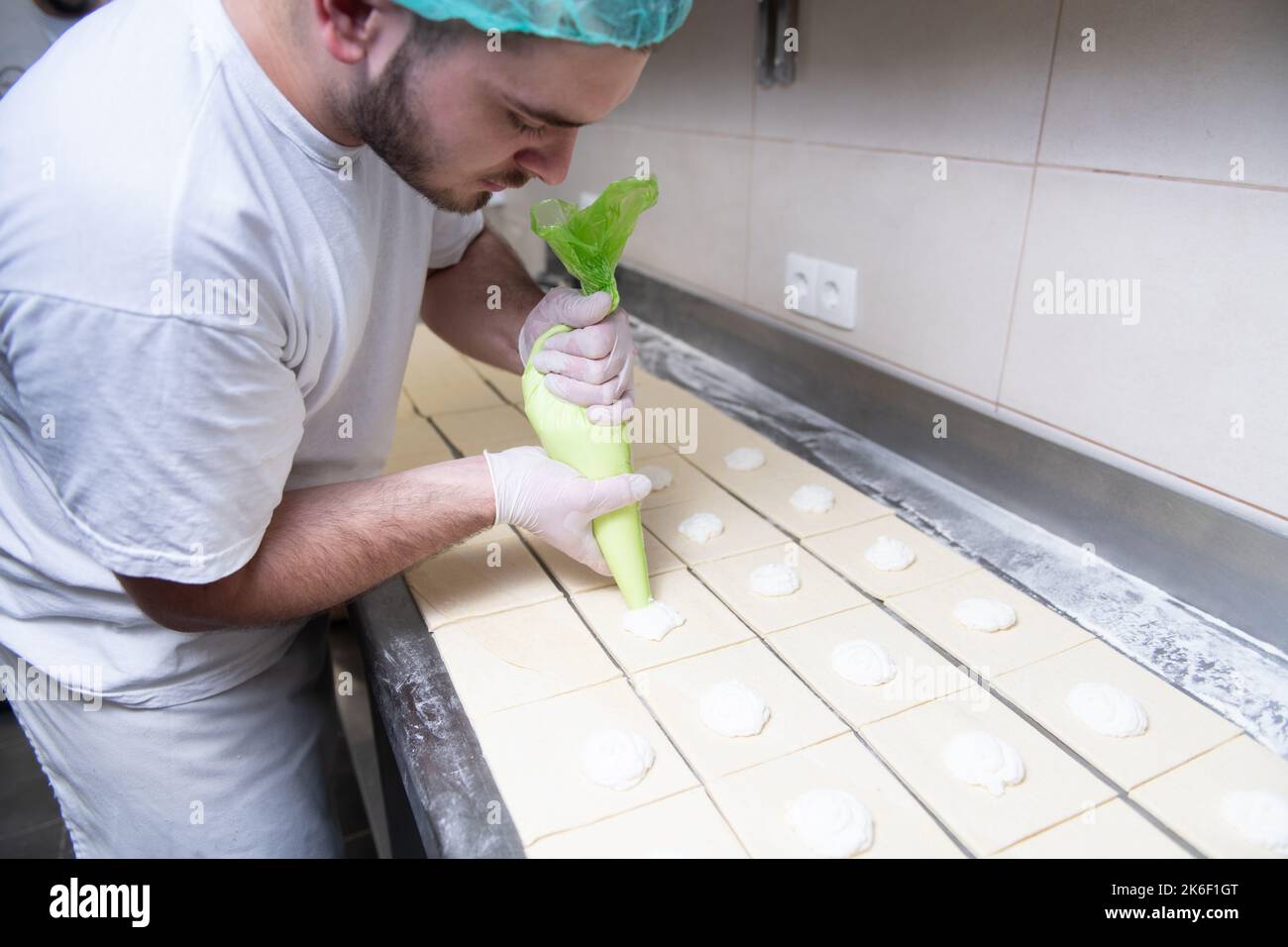 Young Pastry Chef Making Some Cheese Croissant in the Bakery Cooking ...