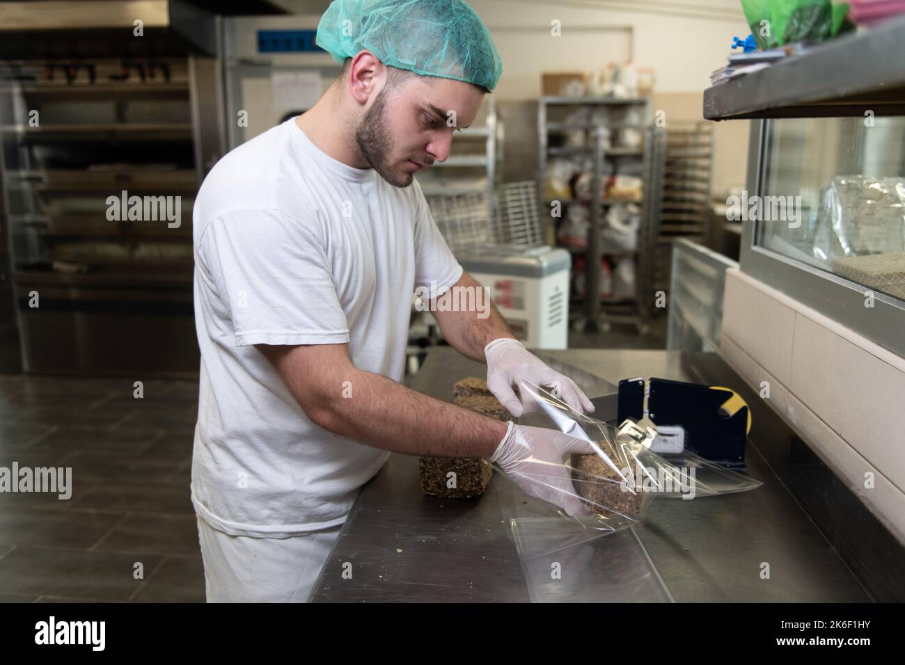 Working Baker Packs Baked Goods Into Individual Bag for Sale Stock Photo - Alamy