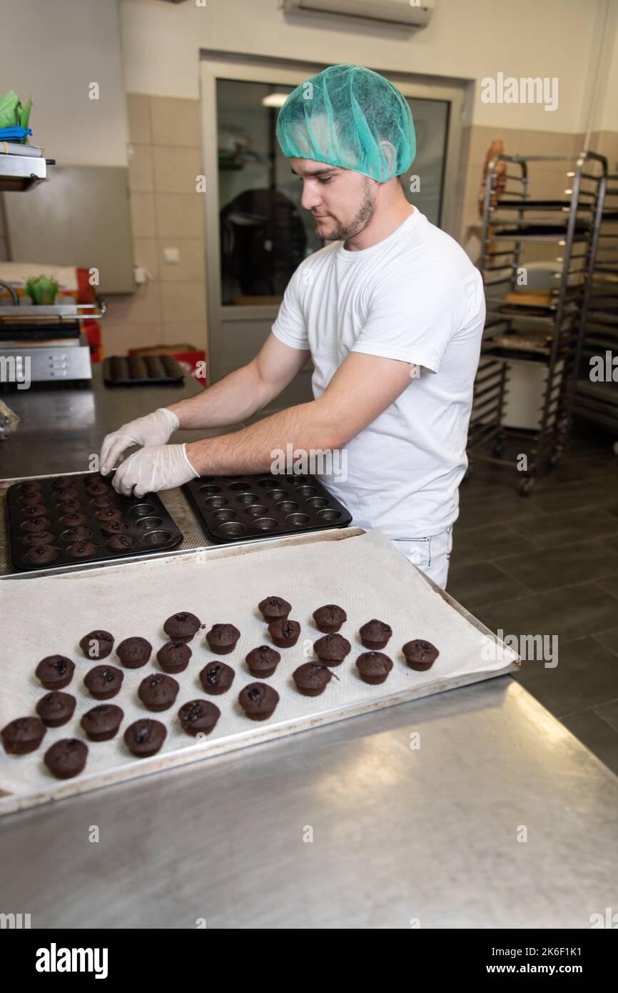 Male Chef Preparing or Decorating Chocolate Cupcake Muffins Stock Photo ...