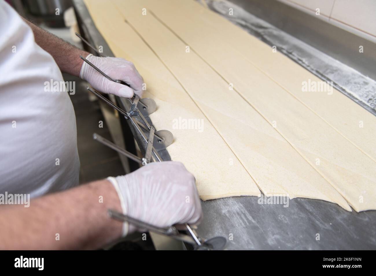 Young Pastry Chef Making Some Croissant in the Bakery Cooking Process ...