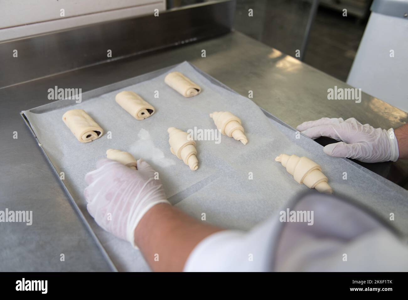 Young Pastry Chef Making Some Croissant in the Bakery Cooking Process ...