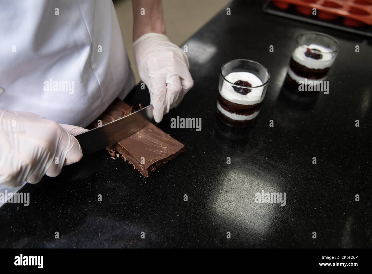 Chocolate Chef is Using Knife Chop Dark Chocolate Bars to Into Small ...