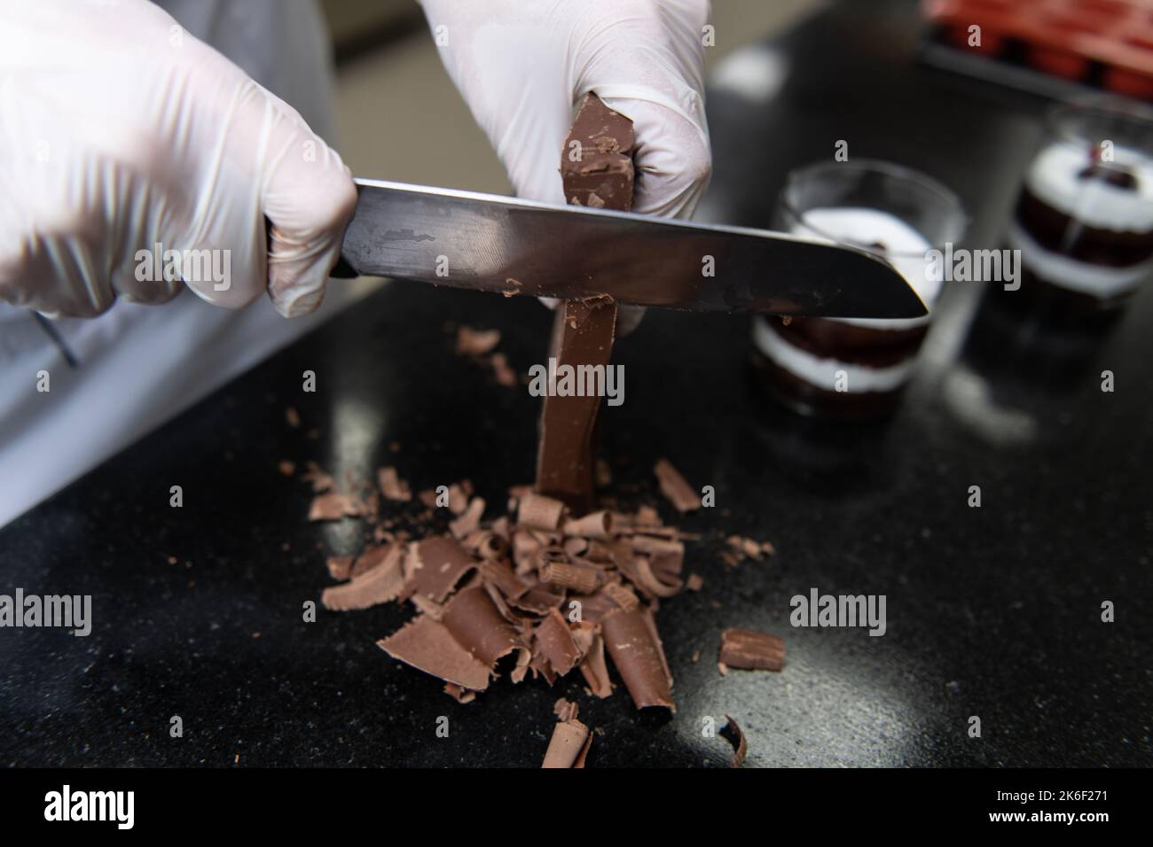 Chocolate Chef is Using Knife Chop Dark Chocolate Bars to Into Small ...