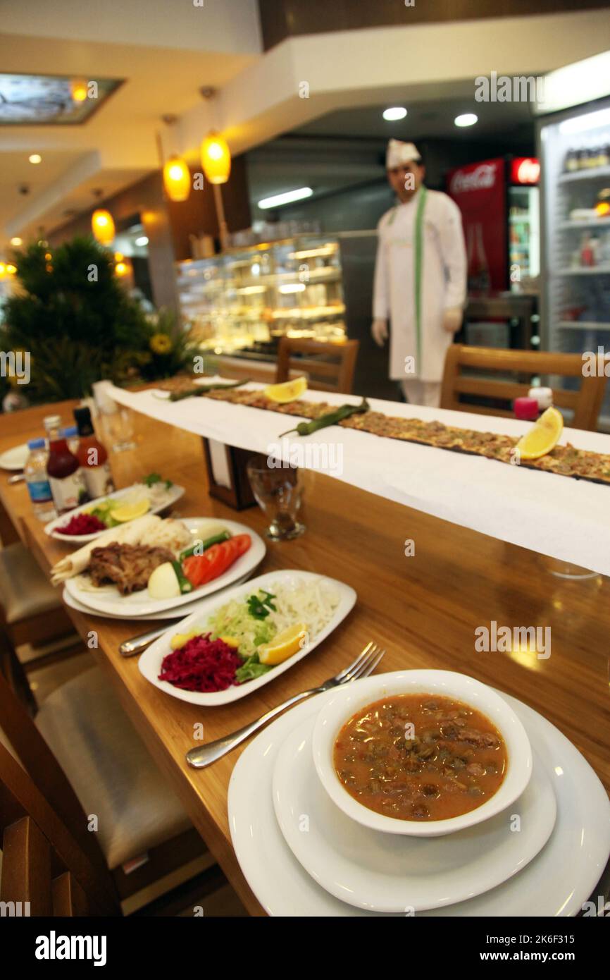 ISTANBUL, TURKEY - FEBRUARY 14: Okra Soup, lahmacun and salad in the ...