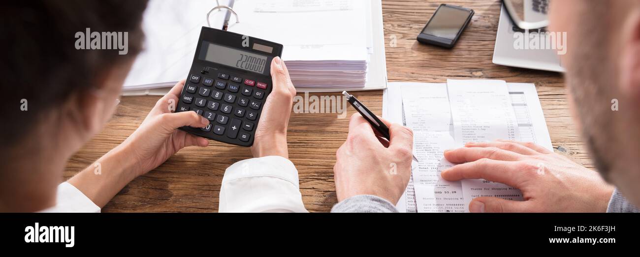 Young Couple Doing Money Paperwork With Calculator Stock Photo - Alamy