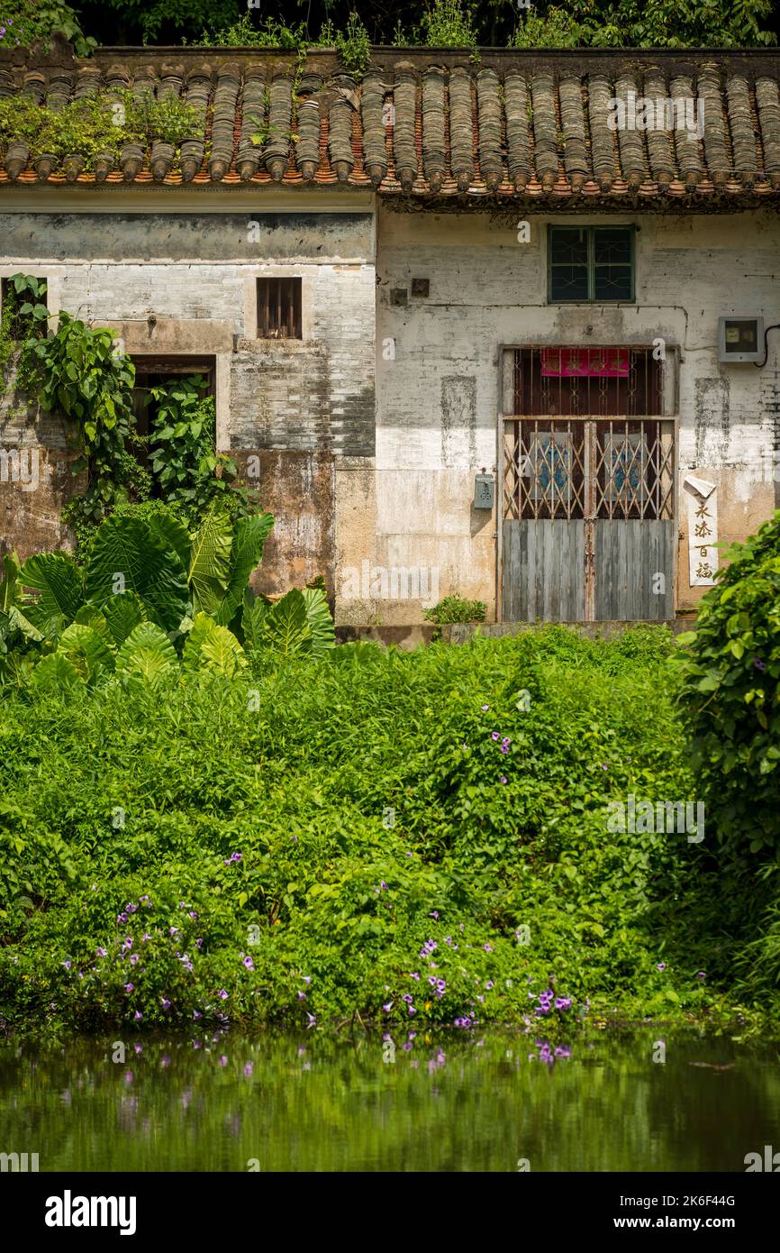 Traditional Chinese village house next to a small lagoon, Nam Chung ...