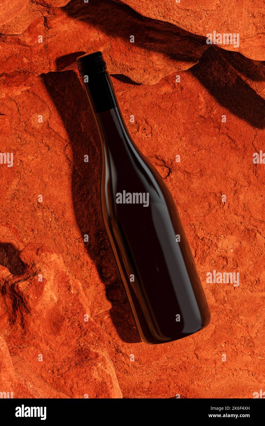 A bottle of red wine lies on red sand rocks Stock Photo - Alamy
