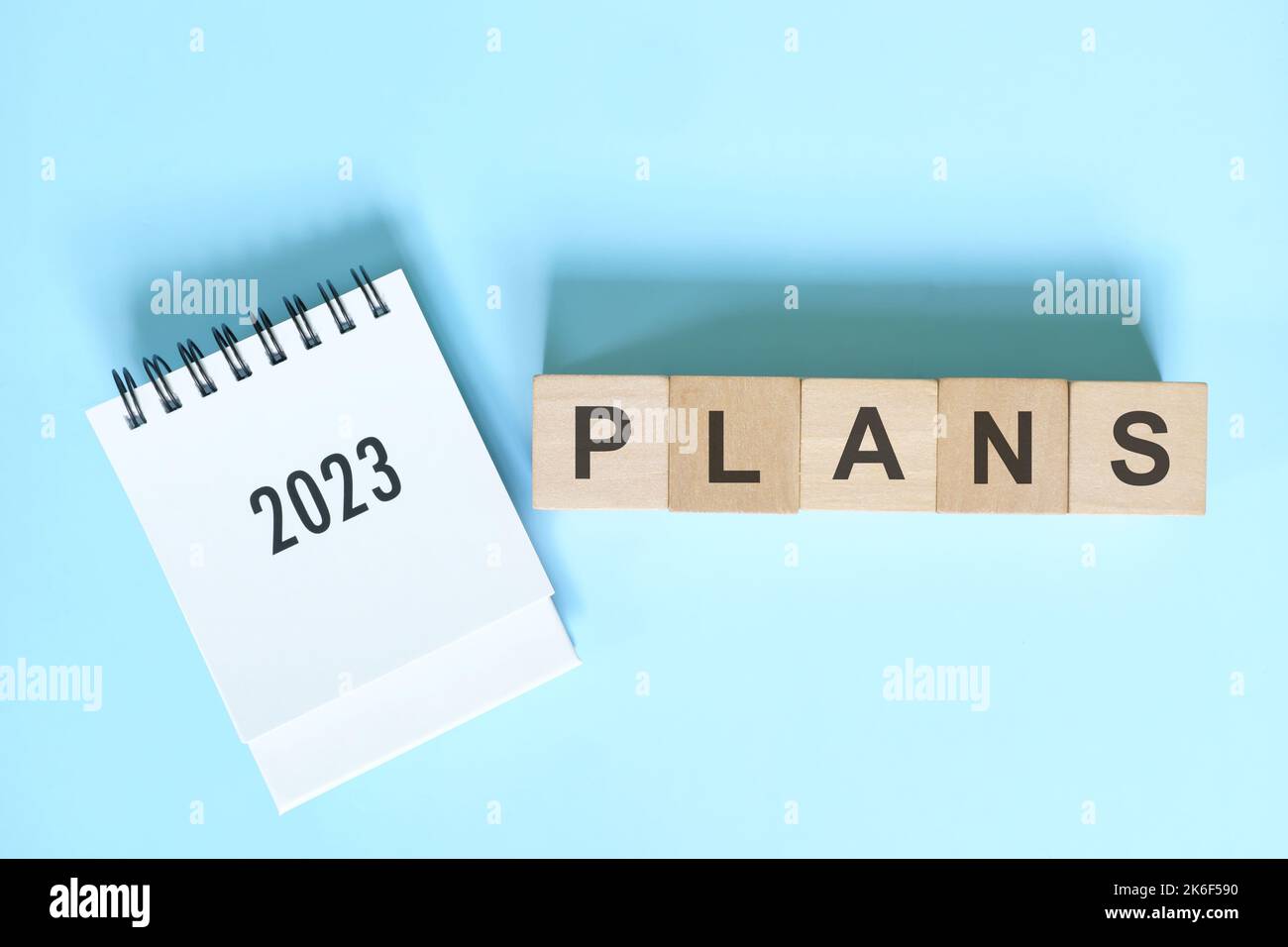 New year 2023 plans concept. Desk calendar flat lay in blue background ...
