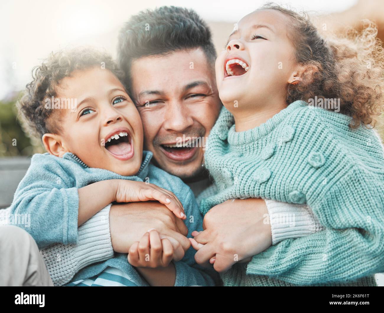 The love of family radiates from our eyes. a father and his kids having ...