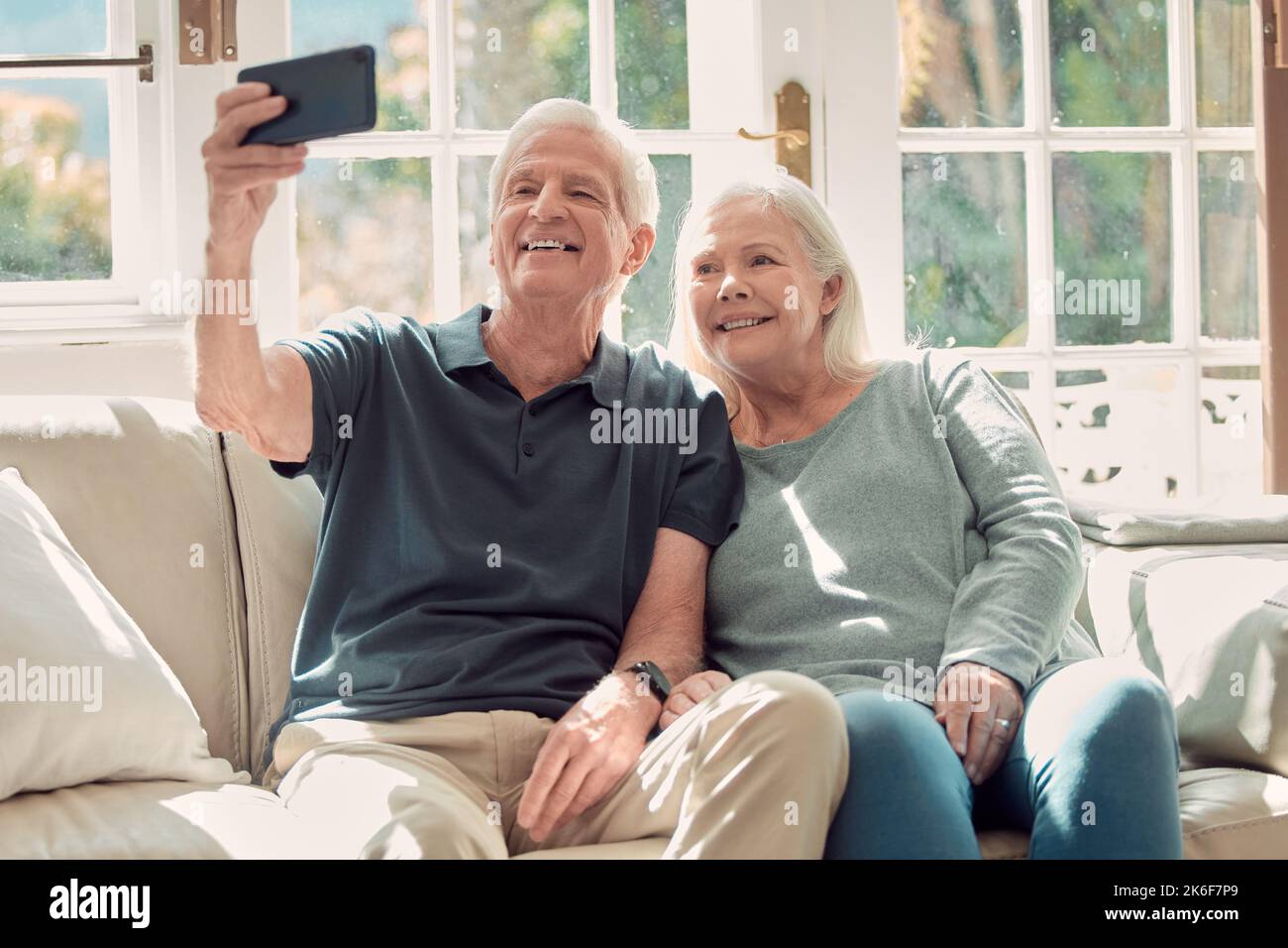 Smile. an affectionate senior couple sitting in their living room at ...