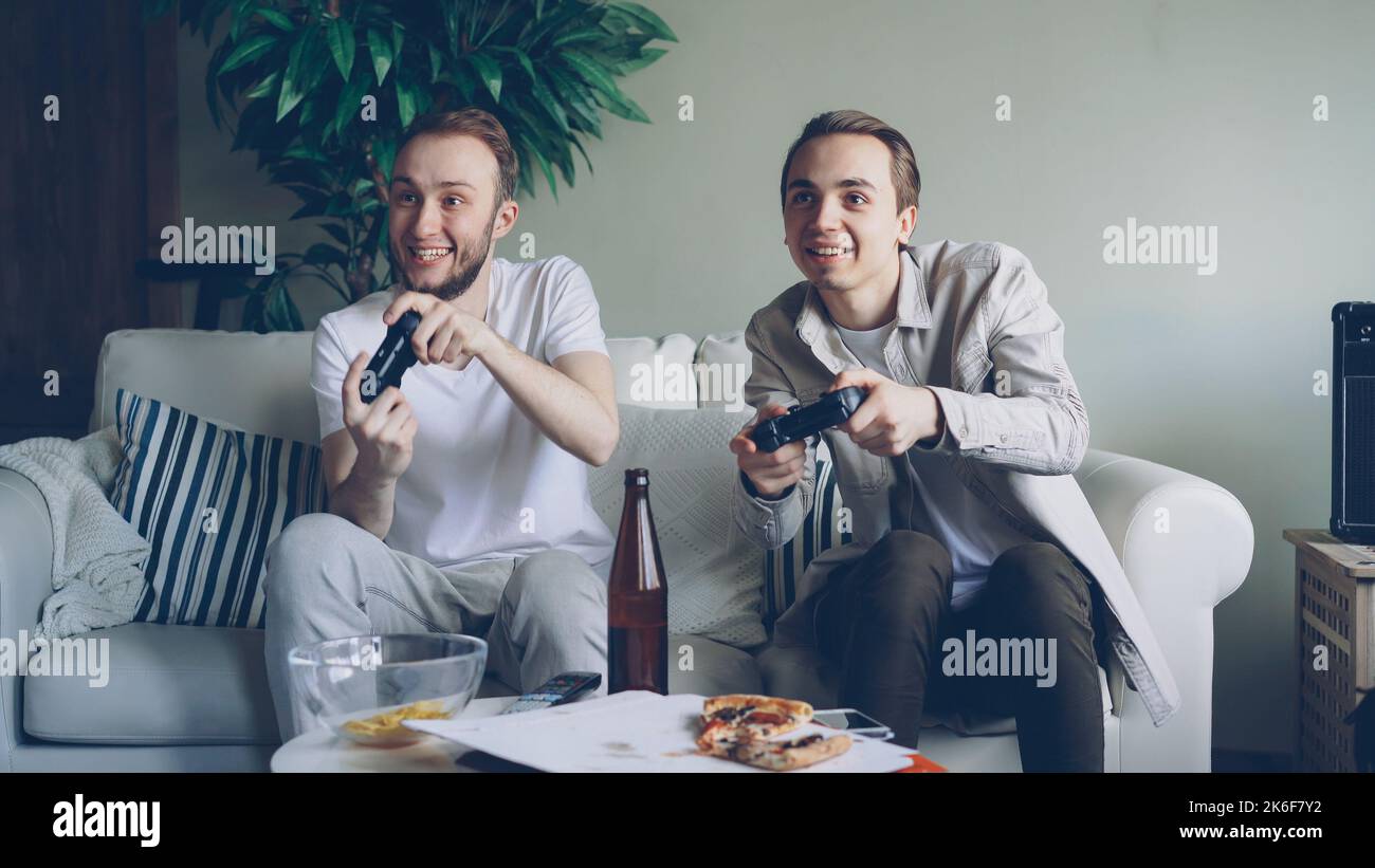 Careless students playing video game watching screen and pressing ...