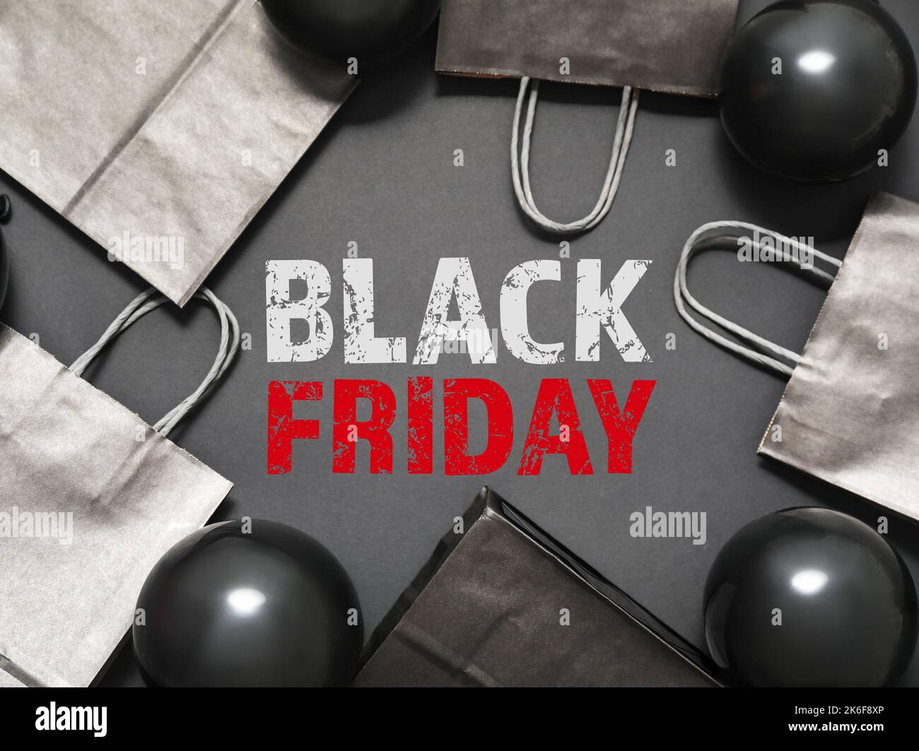 Balloons and shopping bags on dark background. Black Friday sale Stock ...