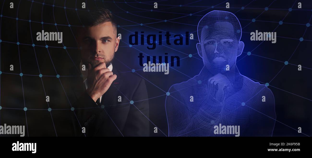 Young businessman with his digital projection on black background ...