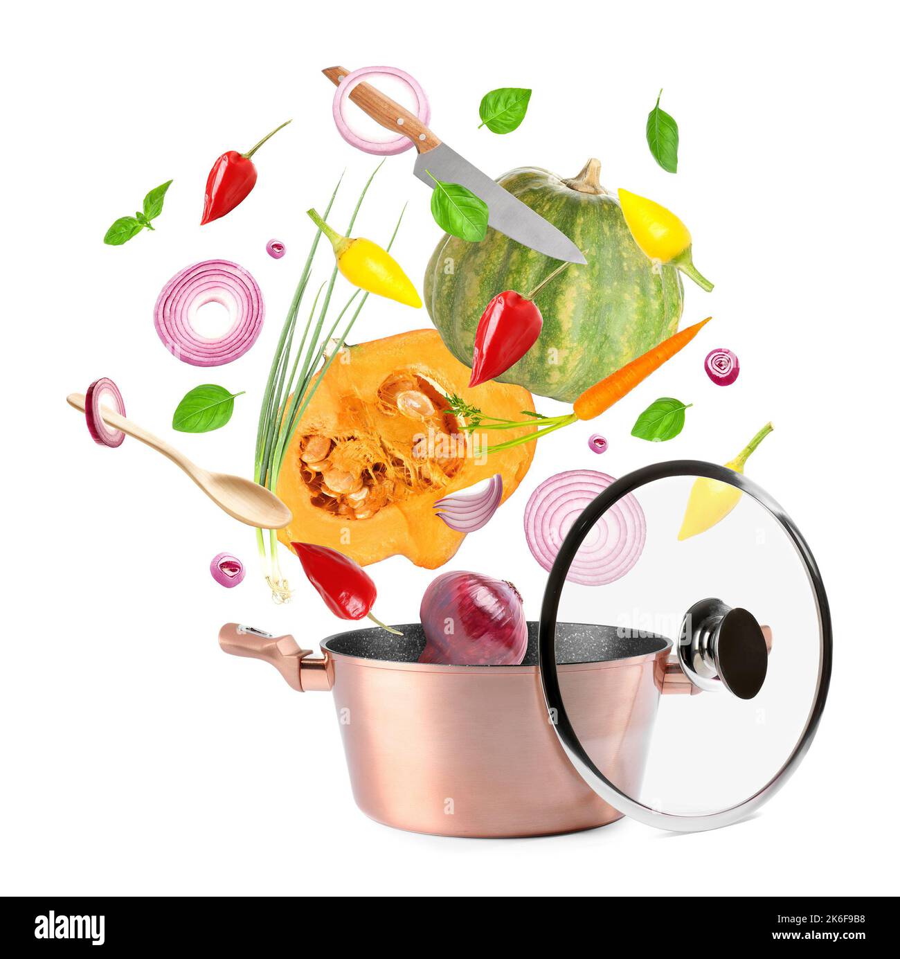 Flying fresh vegetables with utensils and saucepot on white background ...