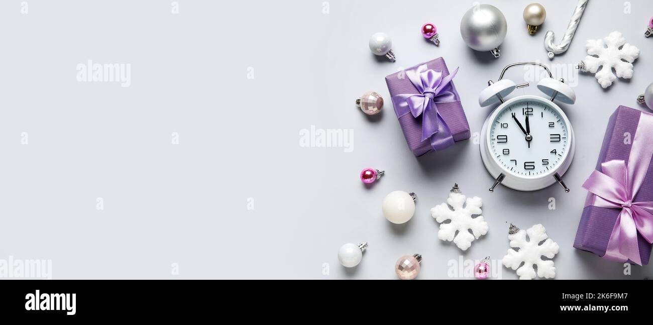 Alarm clock and Christmas decor on light background with space for text ...