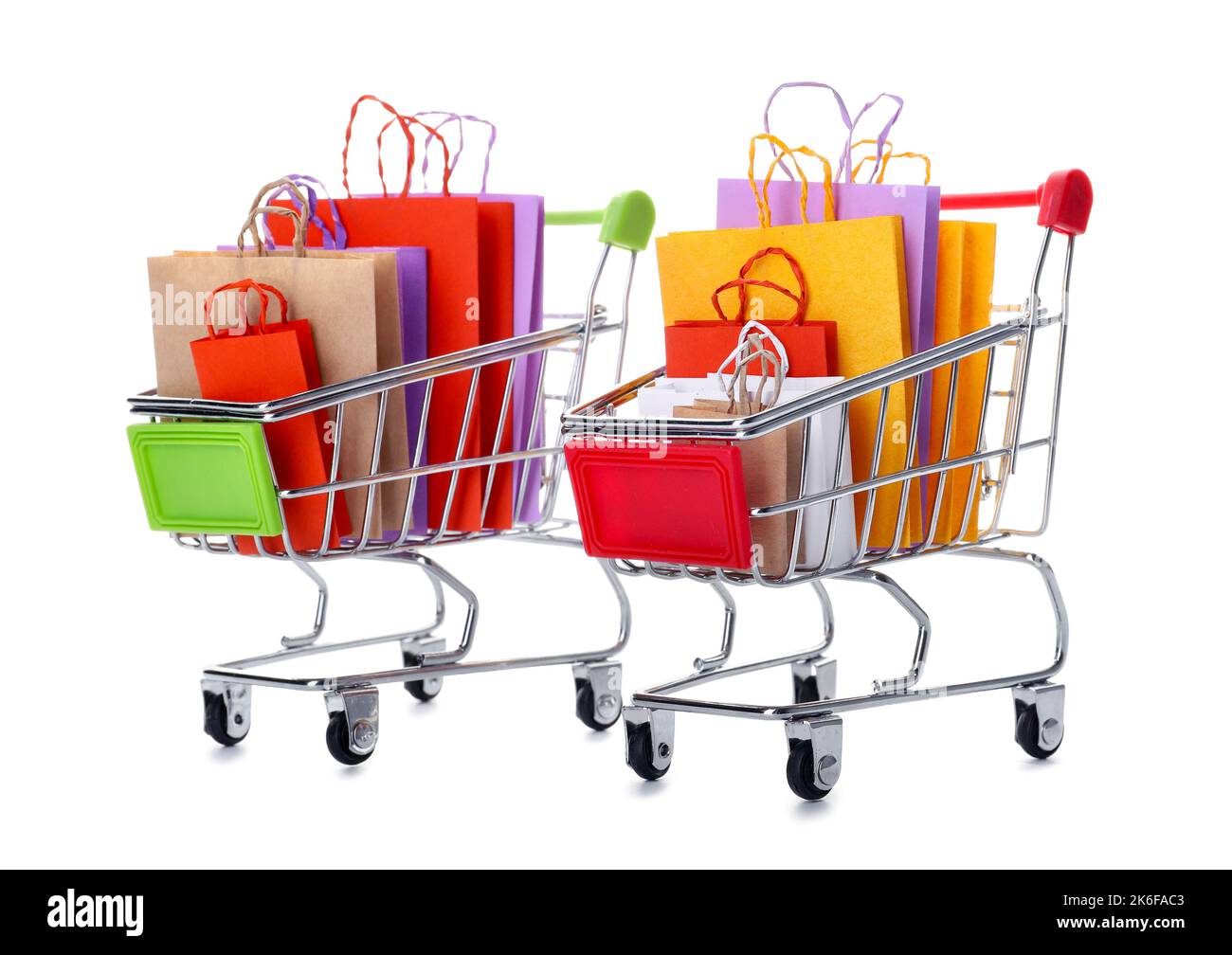 Shopping carts with paper bags on white background Stock Photo - Alamy