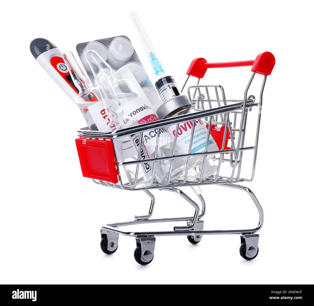 Shopping cart with medicines, thermometer and syringe on white ...