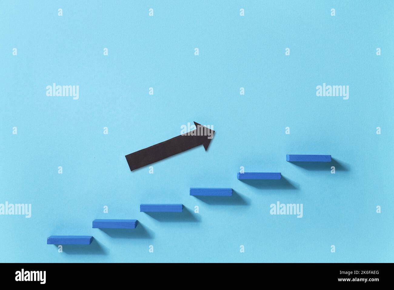Color blocks and arrow on blue background Stock Photo - Alamy