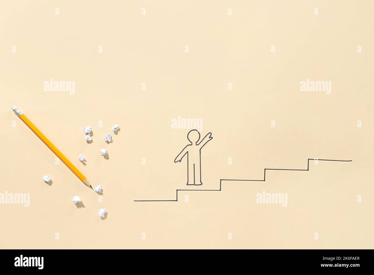 Drawing of person, ladder, pencil and crumpled paper on color ...