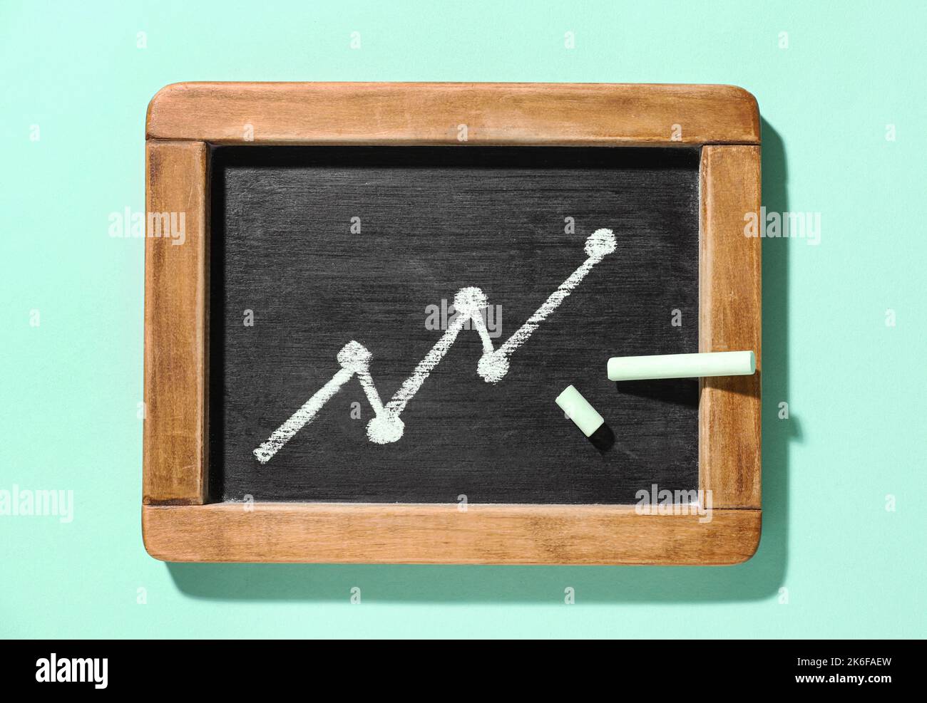 Board with drawing of diagram on color background Stock Photo - Alamy