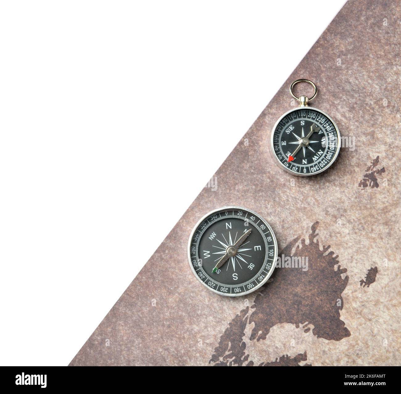 Compasses and vintage world map on white background, closeup Stock ...