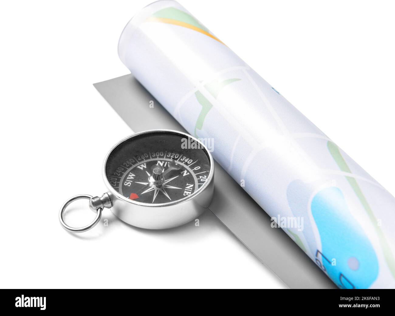 Compass and rolled map on white background, closeup Stock Photo - Alamy