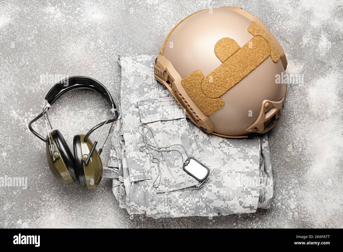 Military uniform, helmet, tag and headphones on grunge background Stock ...