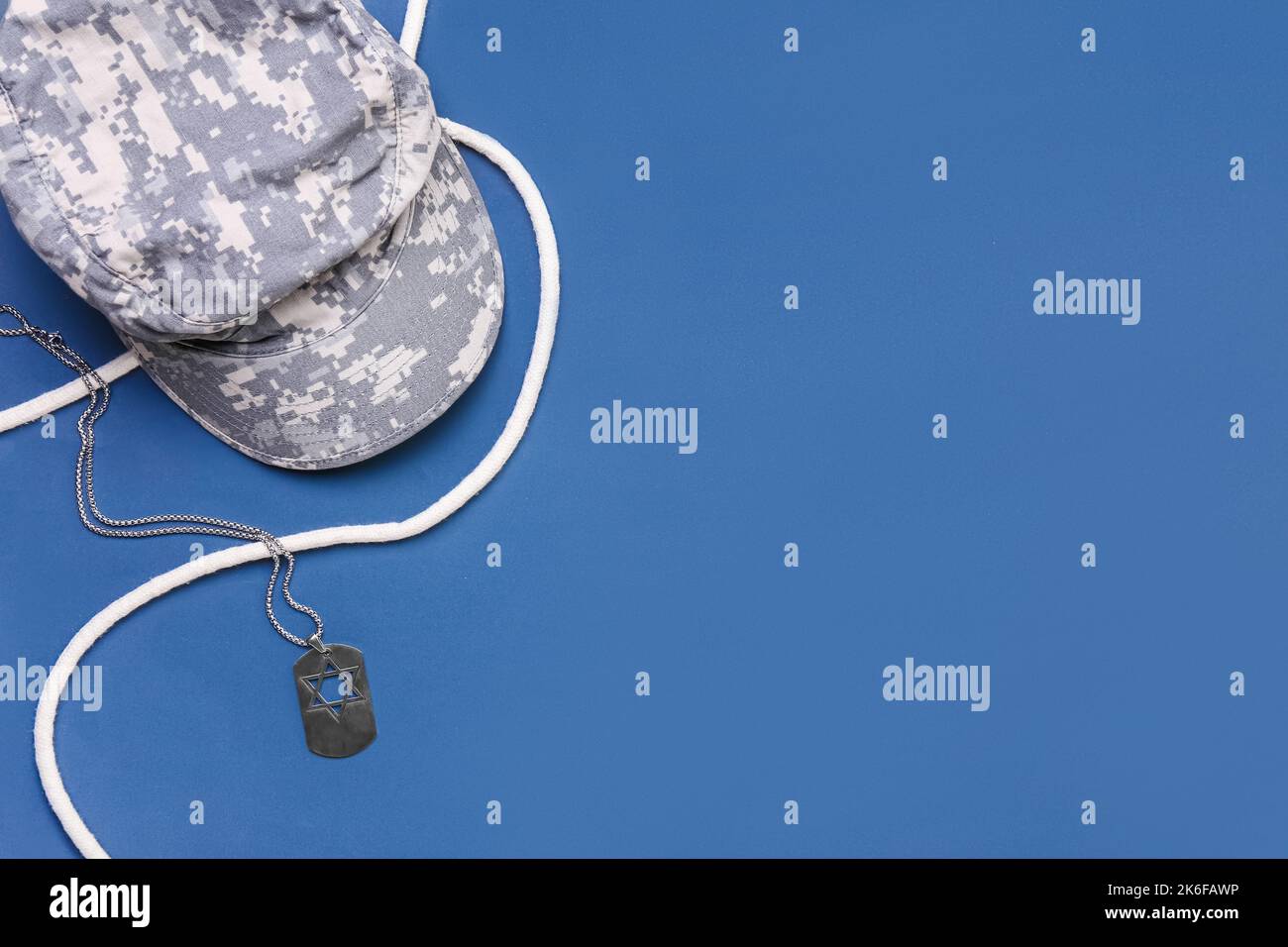 Military cap, tag and rope on blue background Stock Photo - Alamy