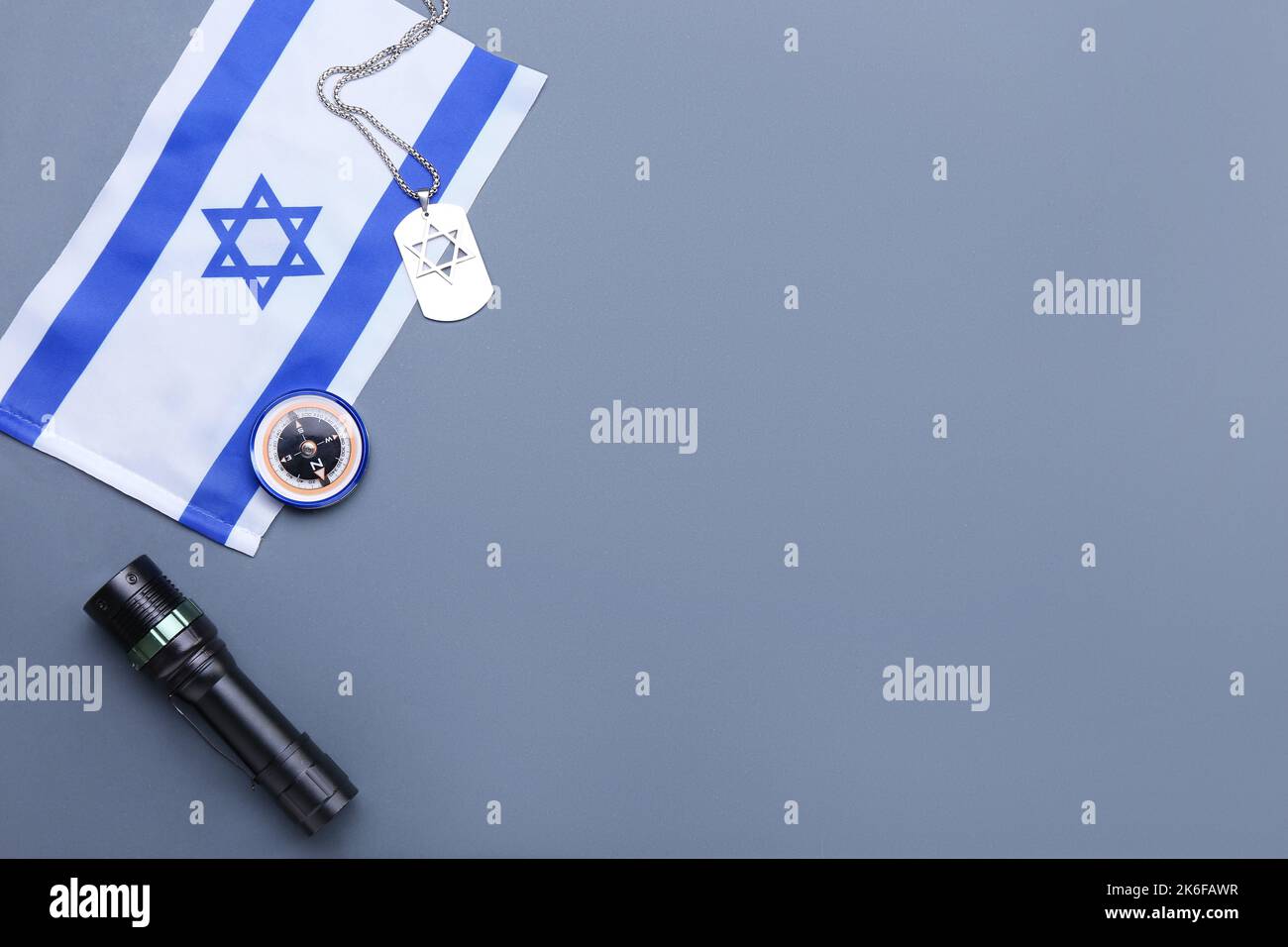 National flag of Israel, military tag, compass and flashlight on grey ...