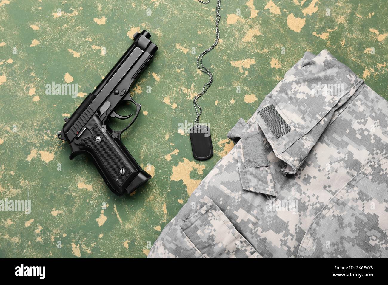 Military uniform, tag and gun on color background Stock Photo - Alamy