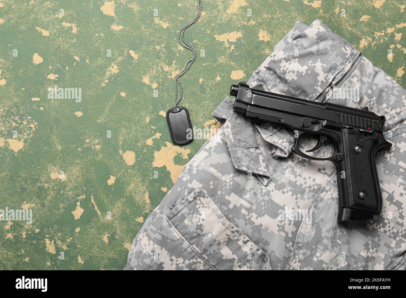 Military tag, gun and uniform on color background Stock Photo - Alamy