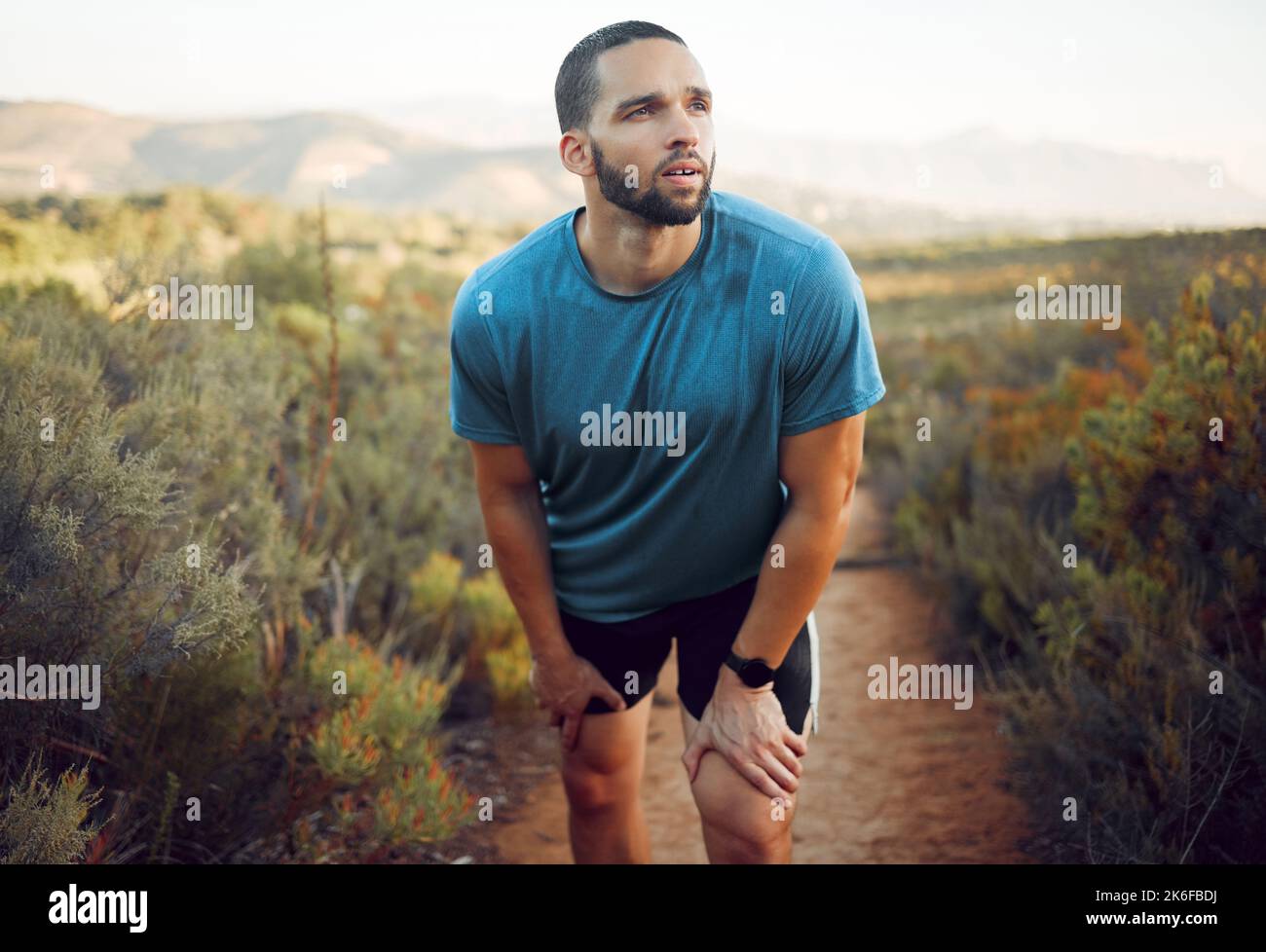 Tired runner, man running on nature park trail fitness training ...