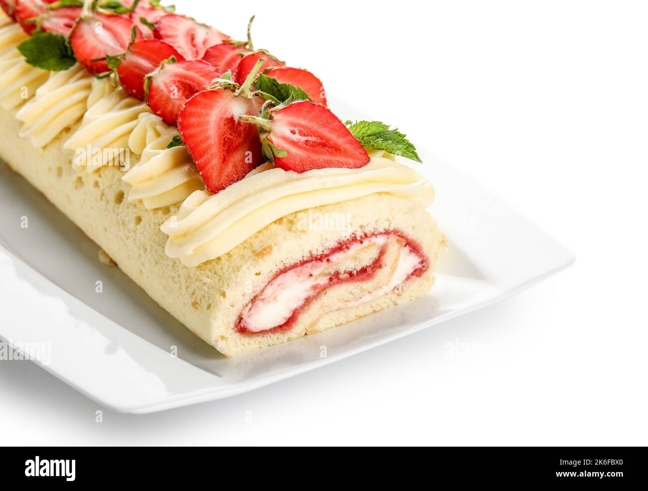 Plate with delicious strawberry roll cake isolated on white background ...