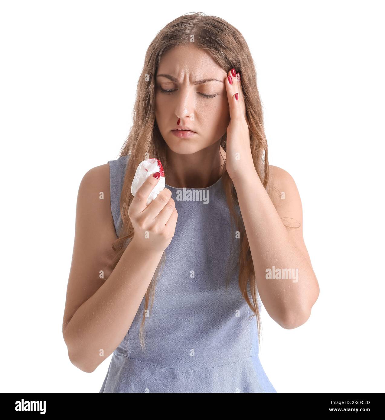 Young woman with nosebleed and tissue on white background Stock Photo ...