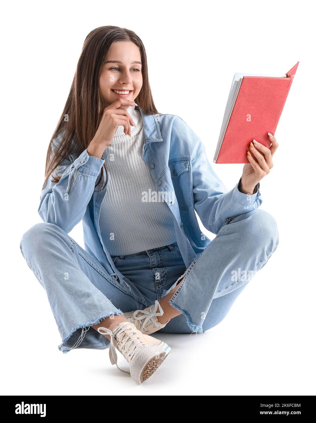 Beautiful woman in denim jacket reading book on white background Stock ...