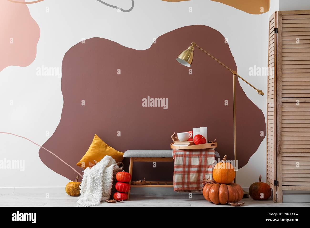 Interior of cozy room with pumpkins, soft bench and lamp Stock Photo ...