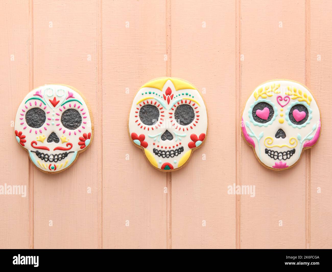 Skull shaped cookies on color wooden background. El Dia de Muertos ...