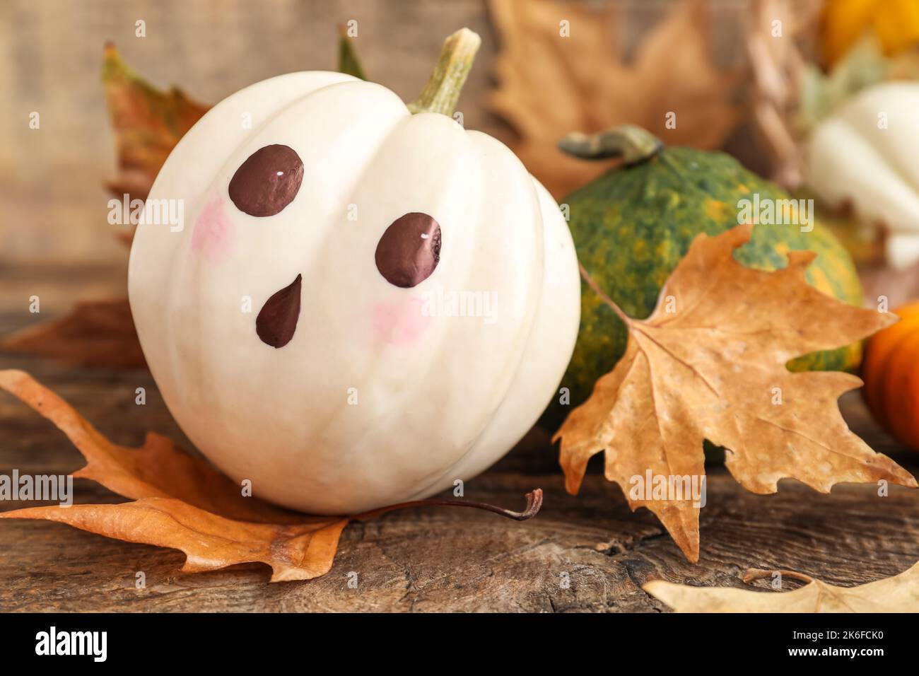 Halloween pumpkins and autumn leaves on wooden table, closeup Stock ...