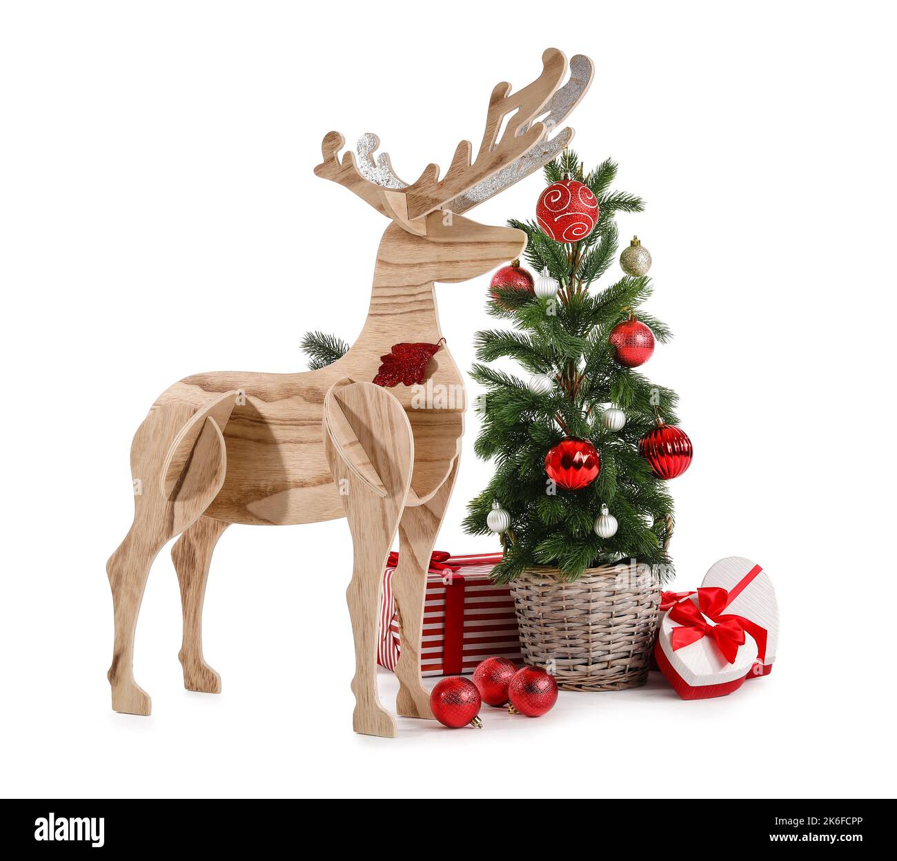 Wooden reindeer with Christmas tree and presents on white background ...