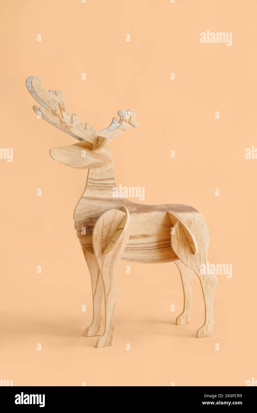 Decorative wooden reindeer on beige background Stock Photo - Alamy