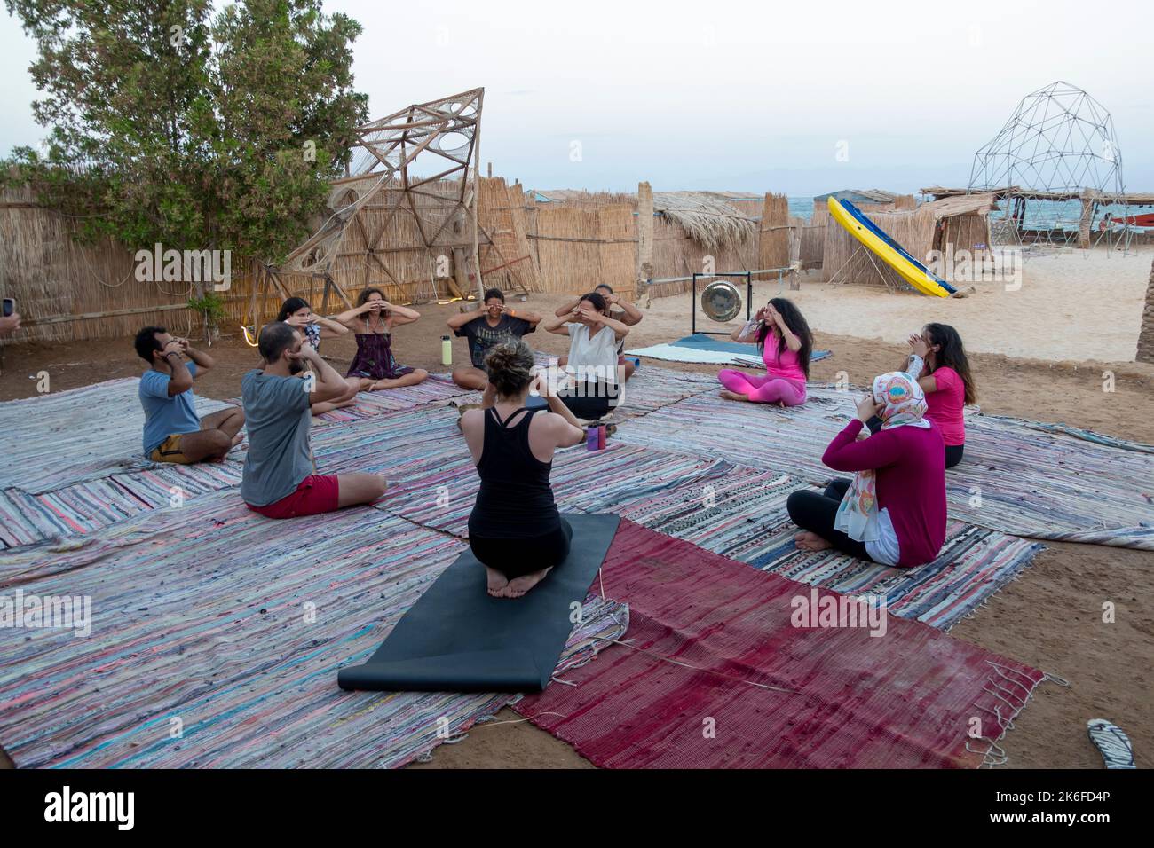 Tourists and Egyptian women practice Yoga in Ras el Satan or Ras ...