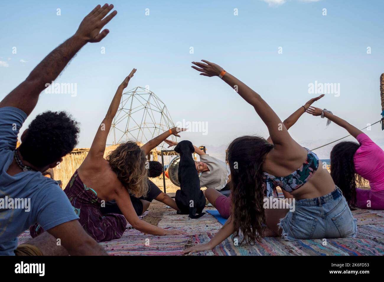 Women practice Yoga in Ras el Satan or Ras Shaitan beach resort area ...