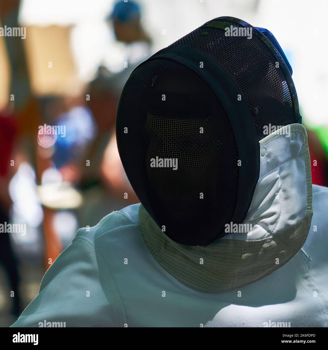 Protected head of a fencer with a black mask Stock Photo - Alamy