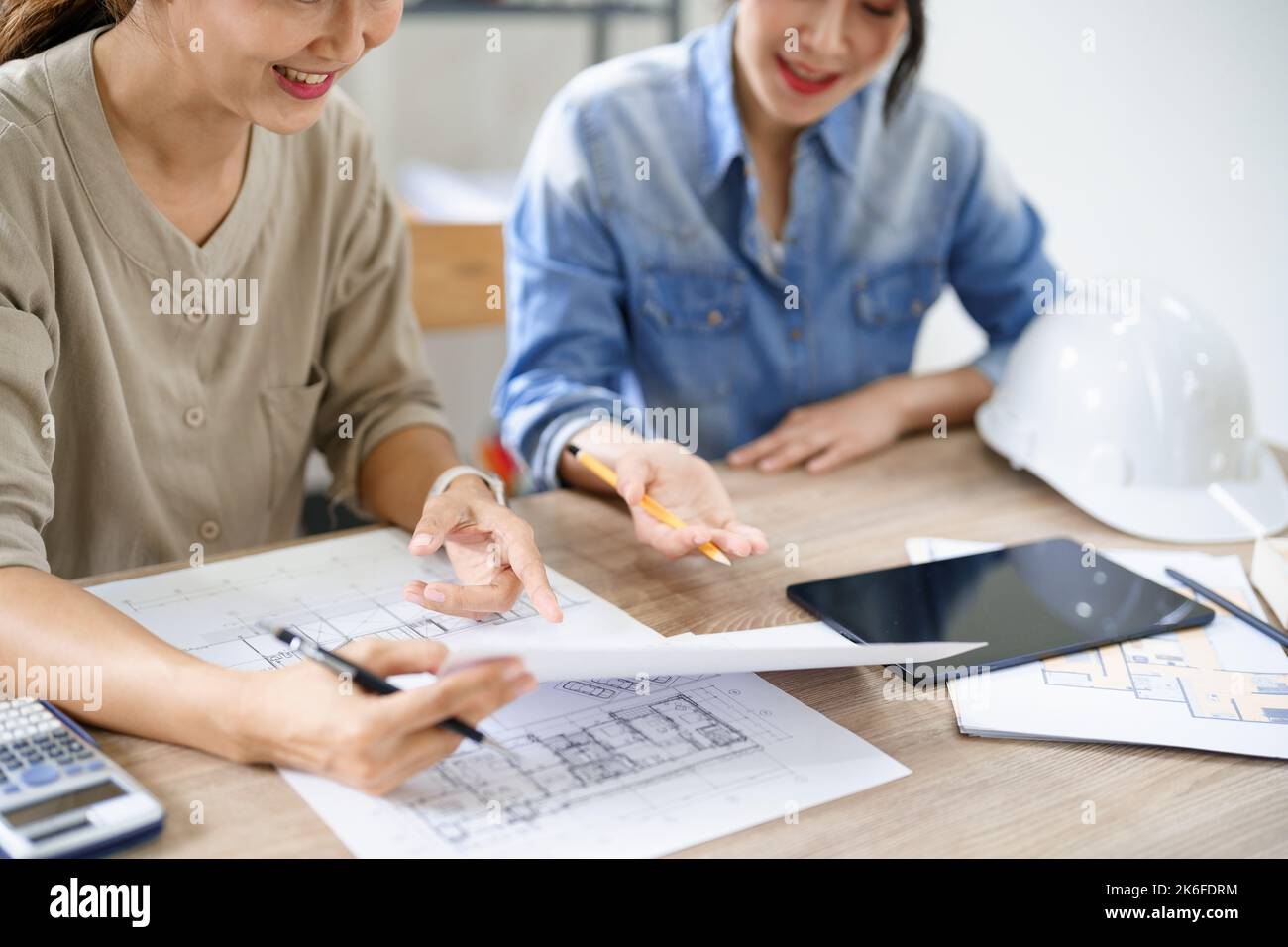 Concept of engineering consulting, Two female engineers discussing ...