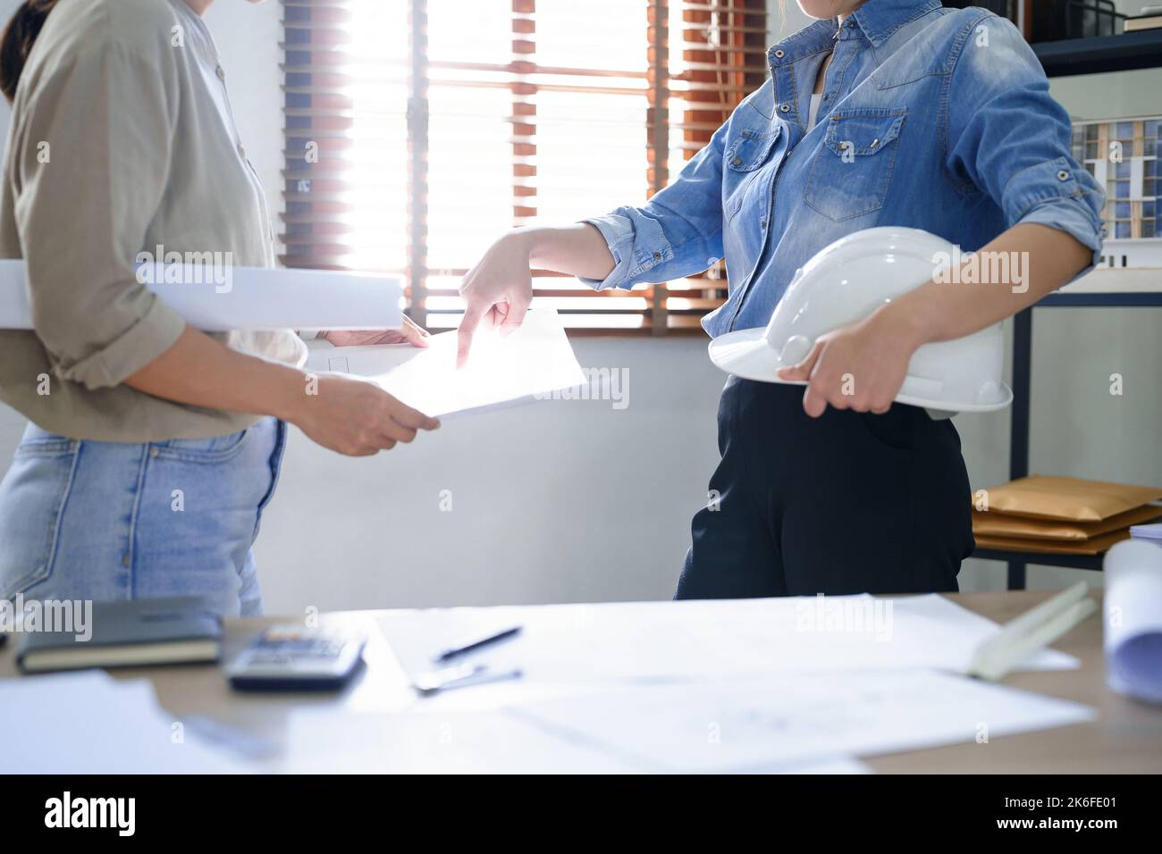 Concept of engineering consulting, Female engineer holding safety ...