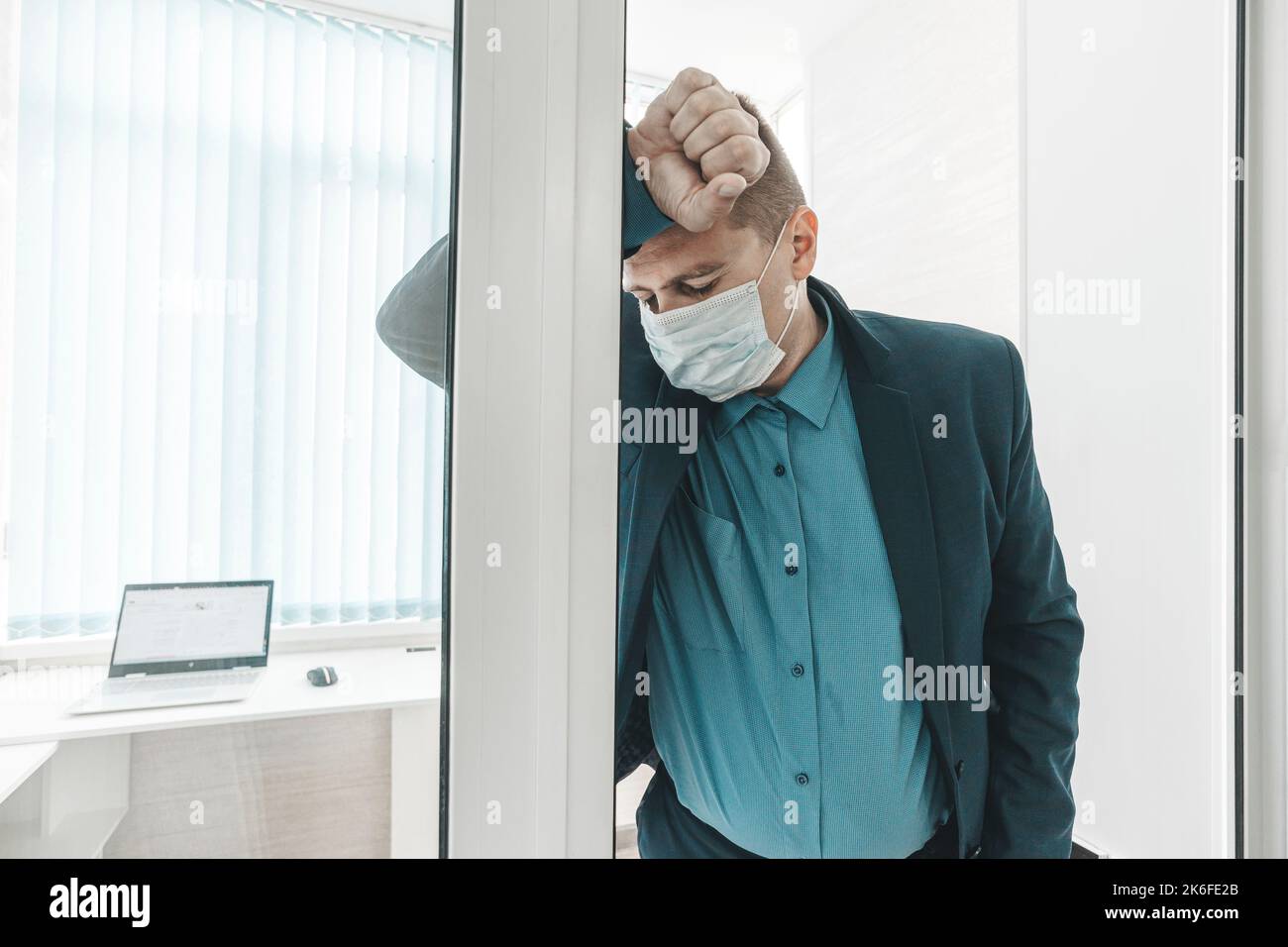 young businessman has fever and feel uncomfortable in the office. An ...